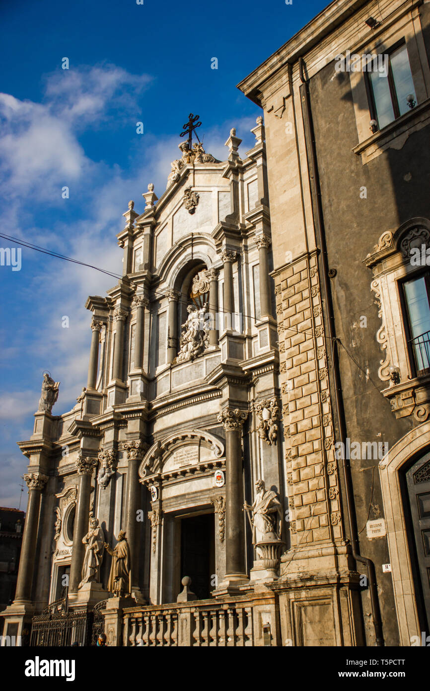 Catania cathedral side view with close baroque architecture building ...