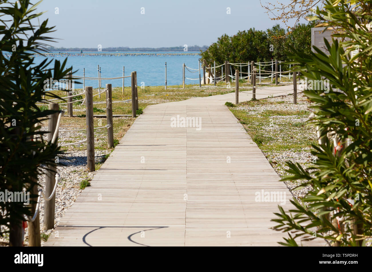 Perspective view of a boardwalk next to the beach in a seaside resort ...