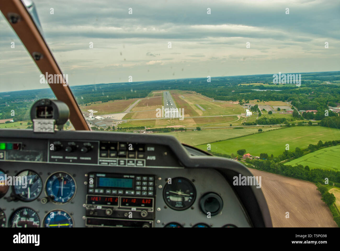 a view from the cockpit of a sports aircraft to the runway of an ...