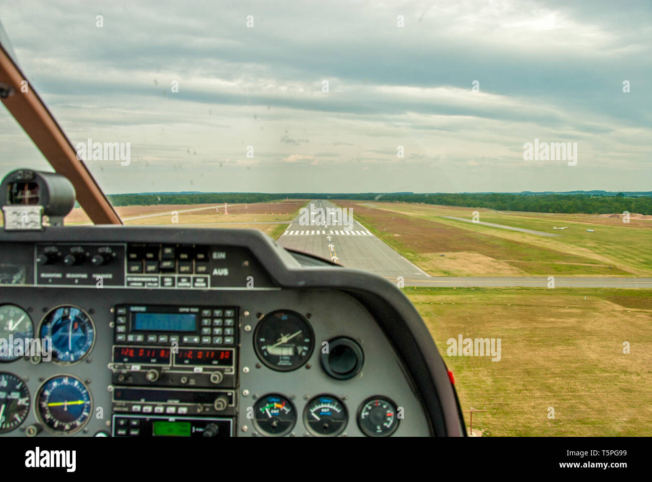 a view from the cockpit of a sports aircraft to the runway of an ...
