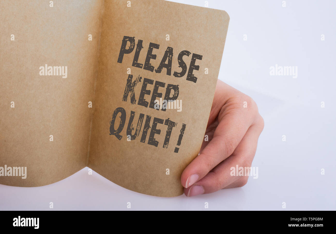 Hand holding a Keep Quiet note as Business concept Stock Photo - Alamy