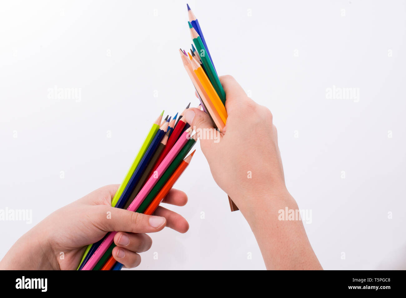 Hand holding color pencils on a white background Stock Photo - Alamy