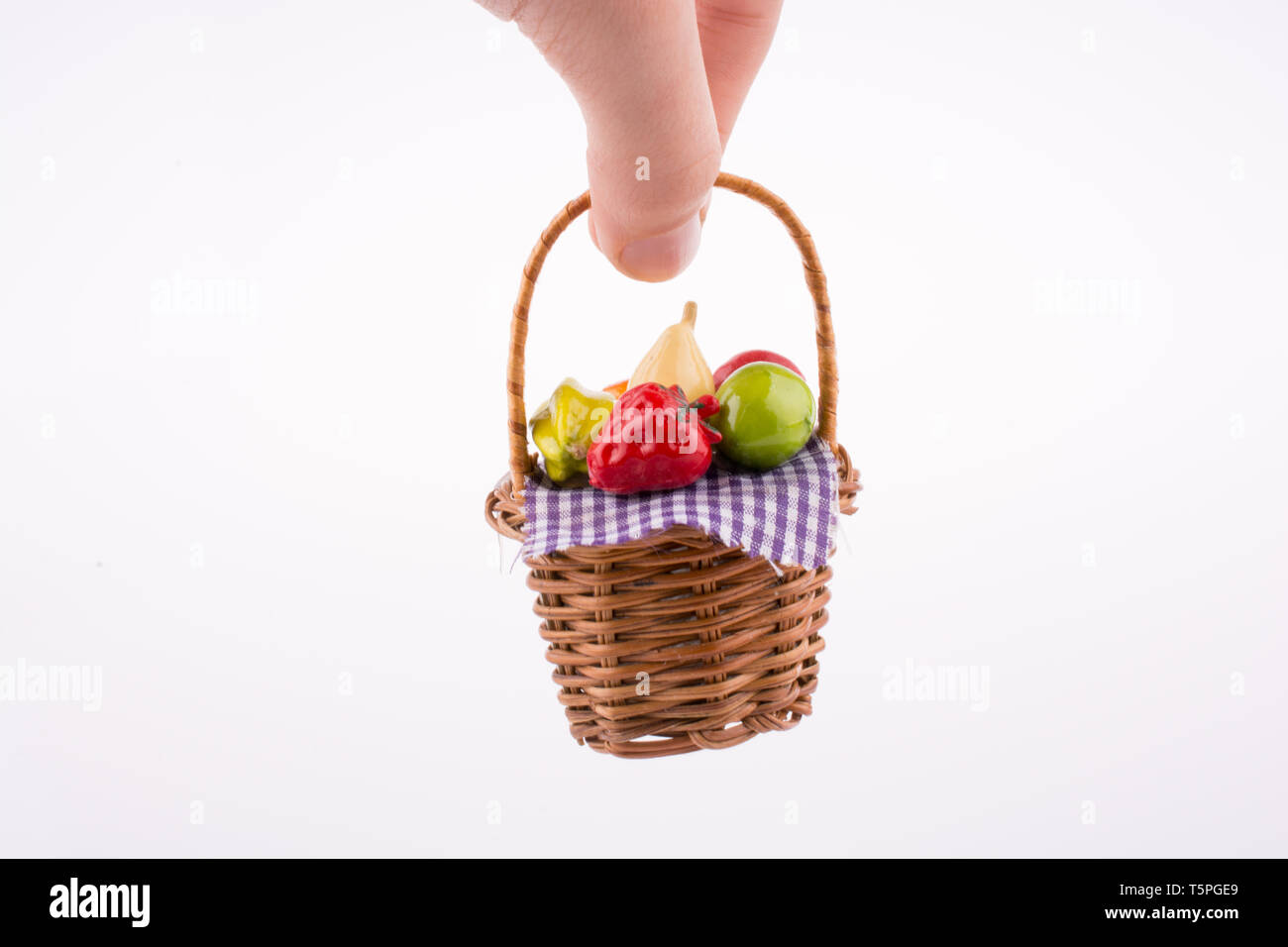 Hand holding a fruit basket on a white background Stock Photo - Alamy