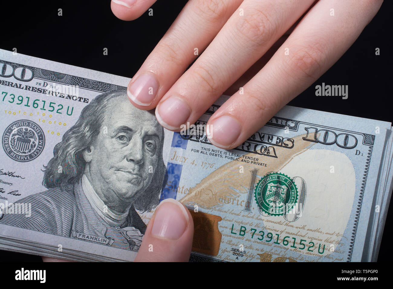 Hand holding American dollar banknotes isolated on white background ...