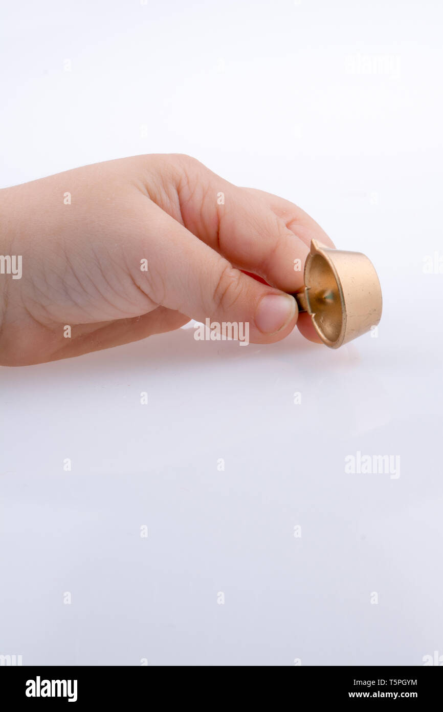 Child holding a tiny cooking pan in hand on a white background Stock ...