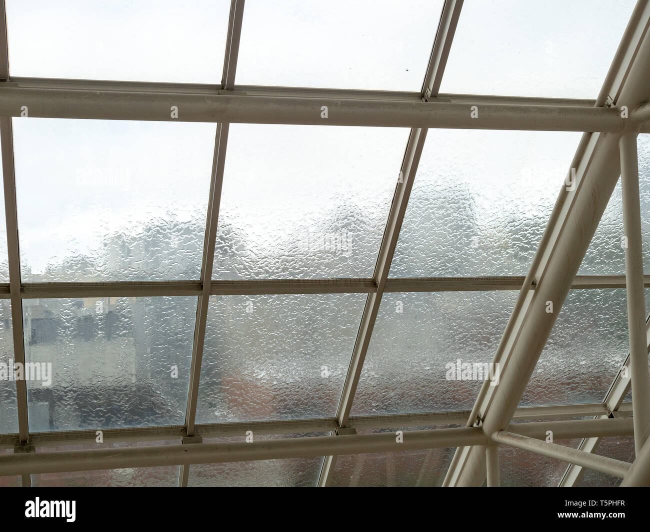 Rain water dripping across windows during a thunderstorm in city Stock ...
