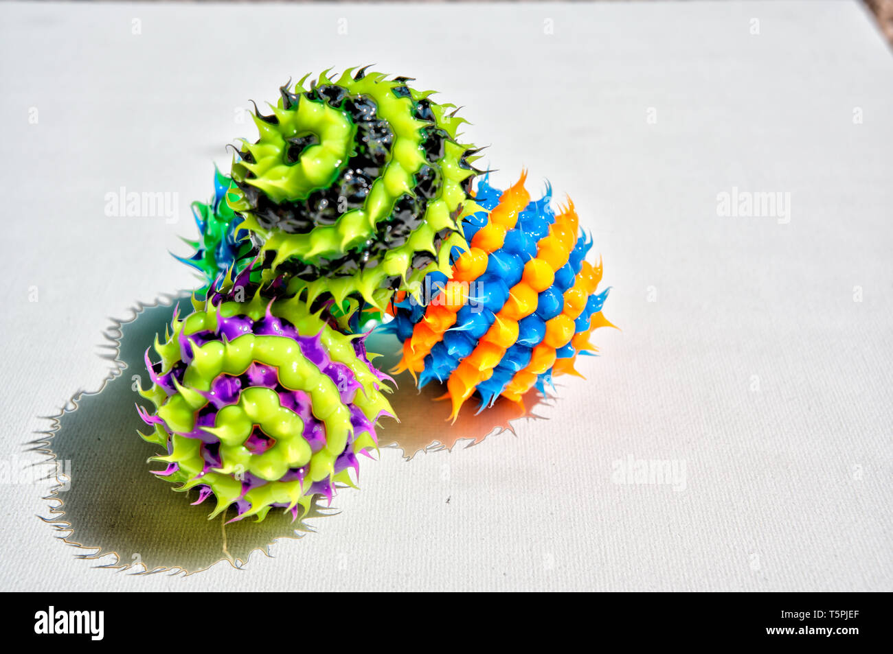 Multi colored striped balls with spikes Stock Photo - Alamy