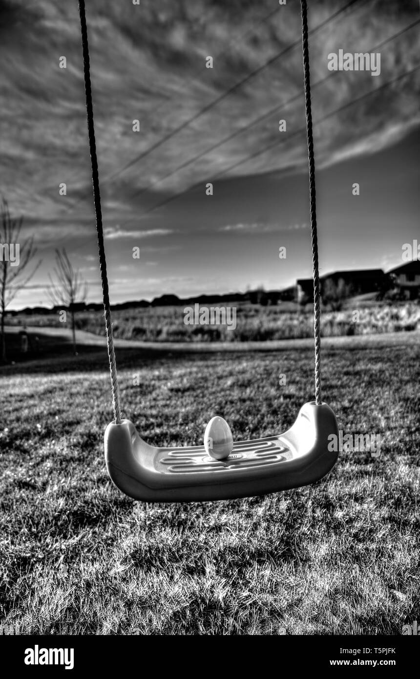 Easter Egg on swing with sky and grass background Stock Photo - Alamy