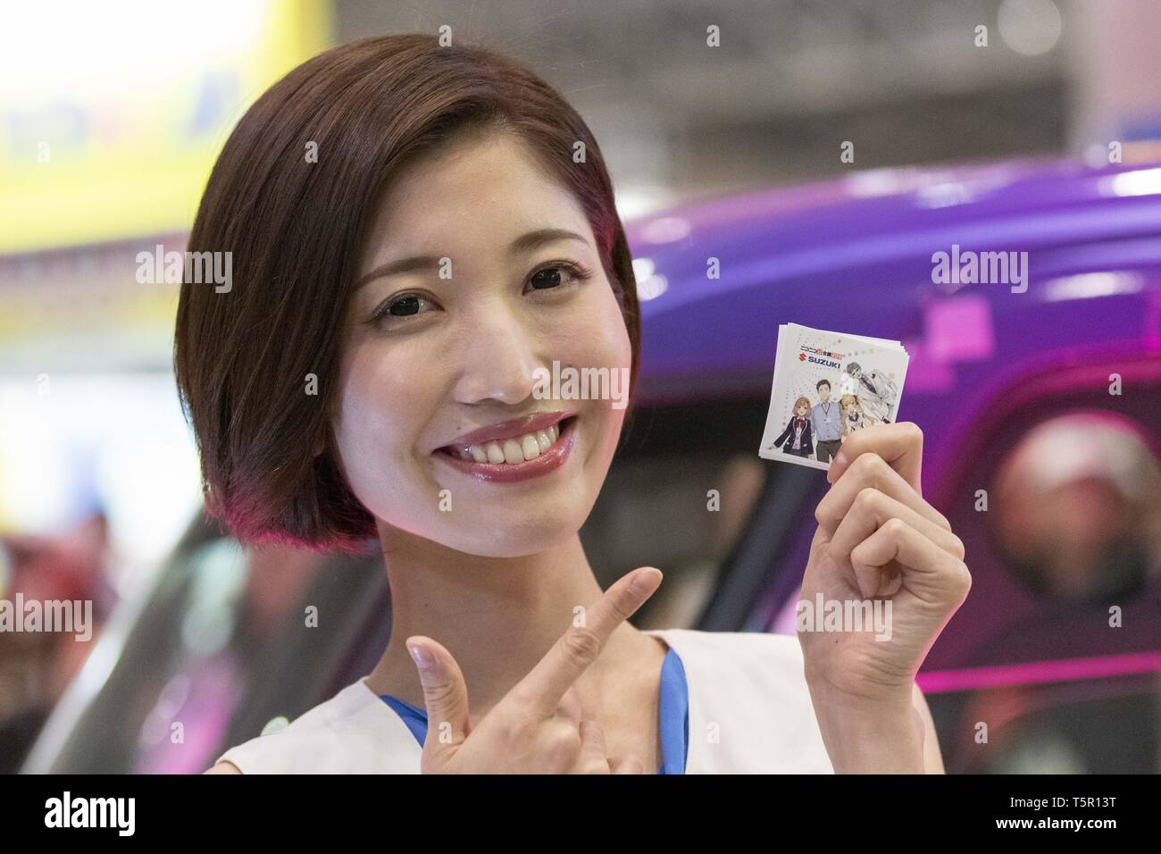 Chiba, Japan. 27th Apr, 2019. A booth assistant poses for a photograph ...