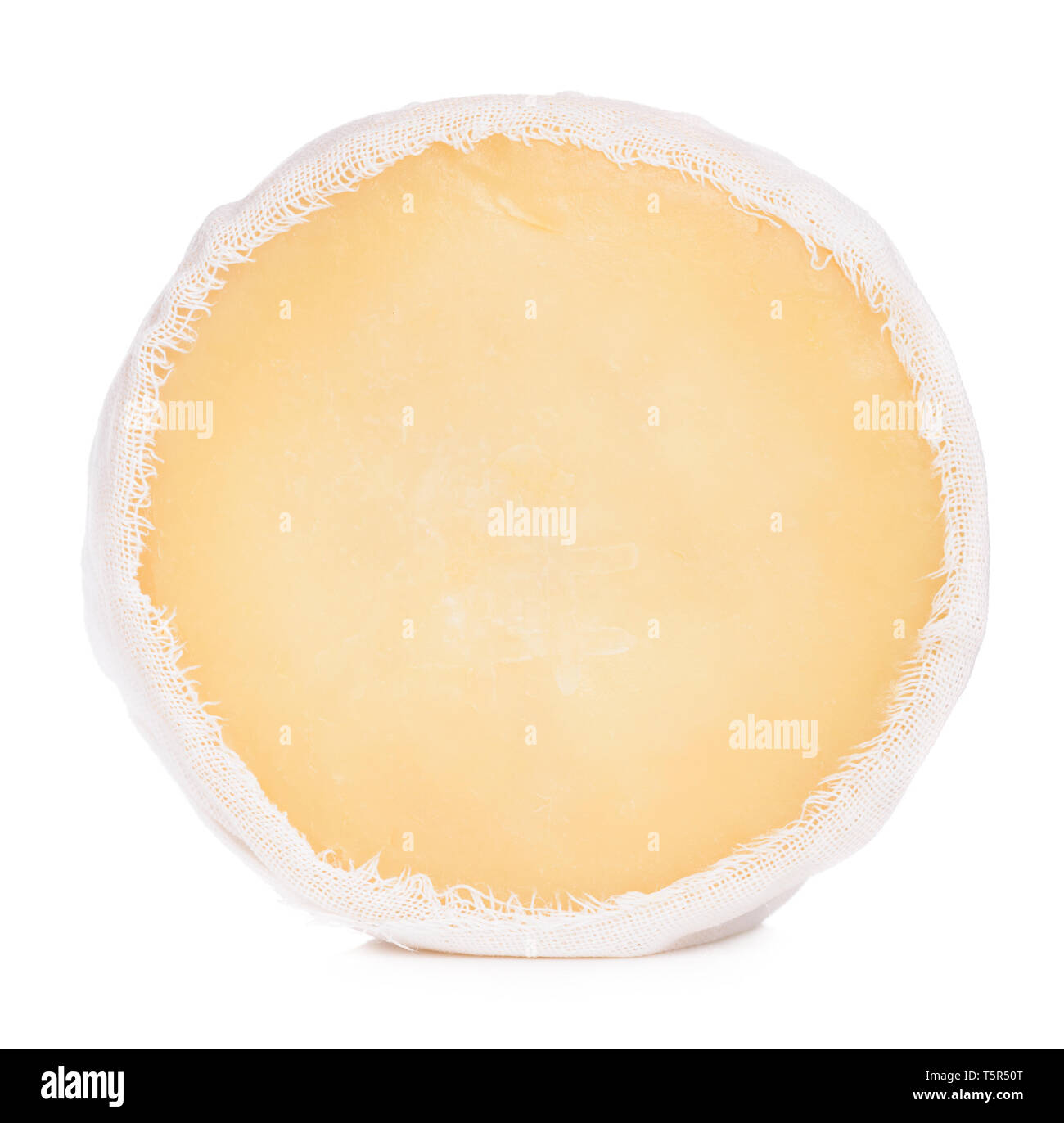 Soft round cheese wrapped in cheesecloth stand on its edge isolated on ...