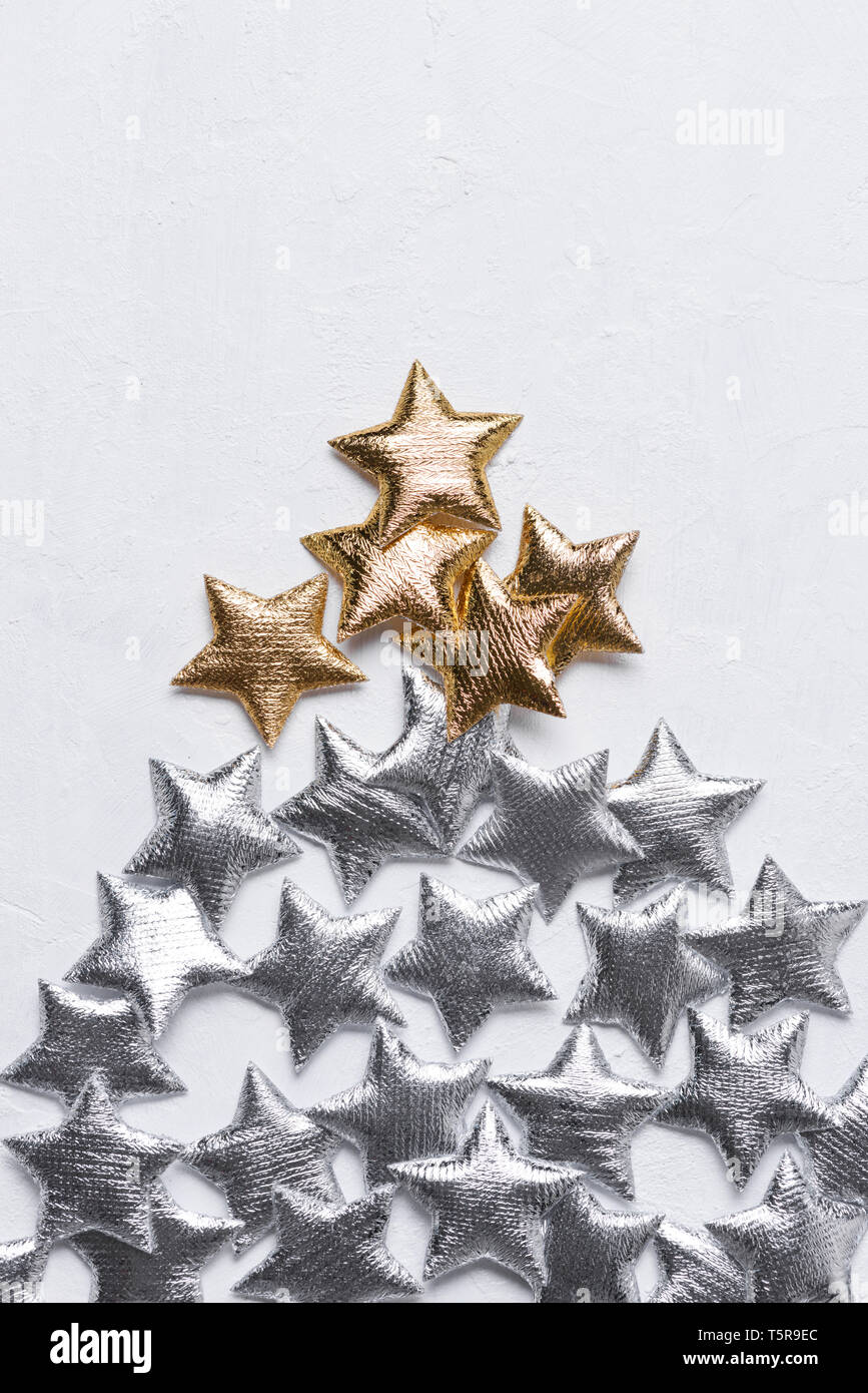 Golden and silver stars in a tree shape chtristmas tree concept on a ...