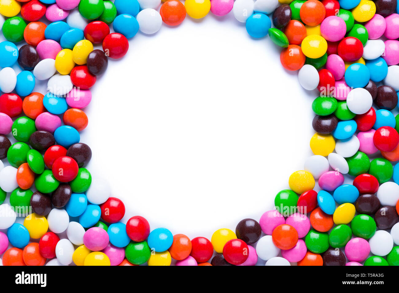 Vibrant colorful small circle candies on white background with white ...