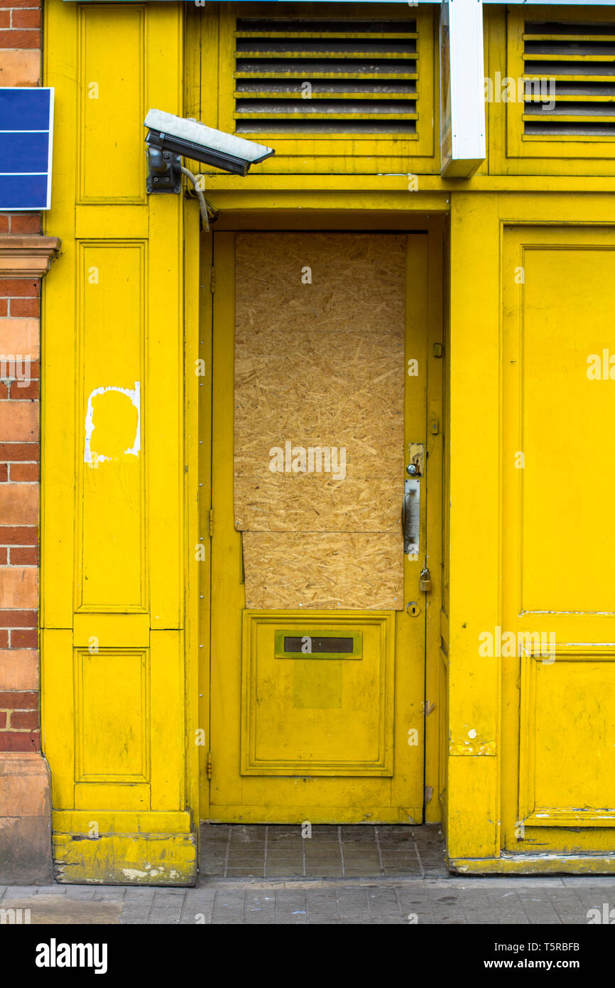 Bright yellow entrance supervised by a video camera. Entry clogged with ...