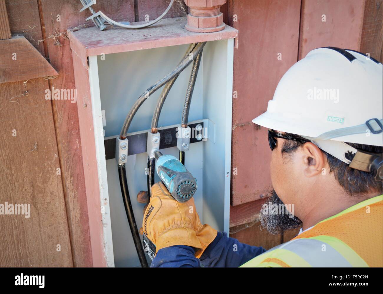 Repairs being done to faulty wiring in older home by trained and ...