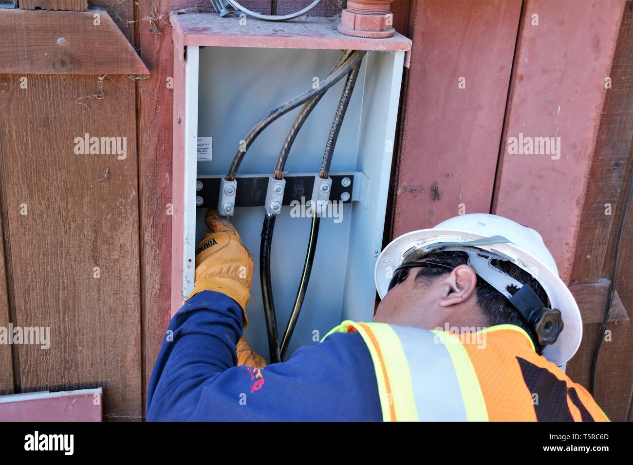 Repairs being done to faulty wiring in older home by trained and ...