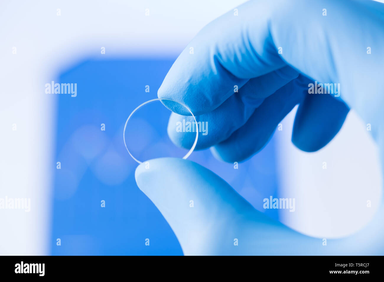 Round piece of transparent plastic, new type of glass or plastic with ...