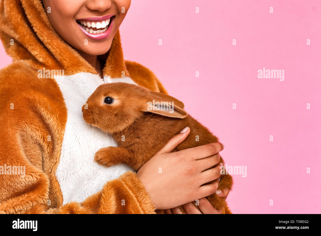 Young Woman In Bunny Kigurumi Standing Isolated On Pink Background