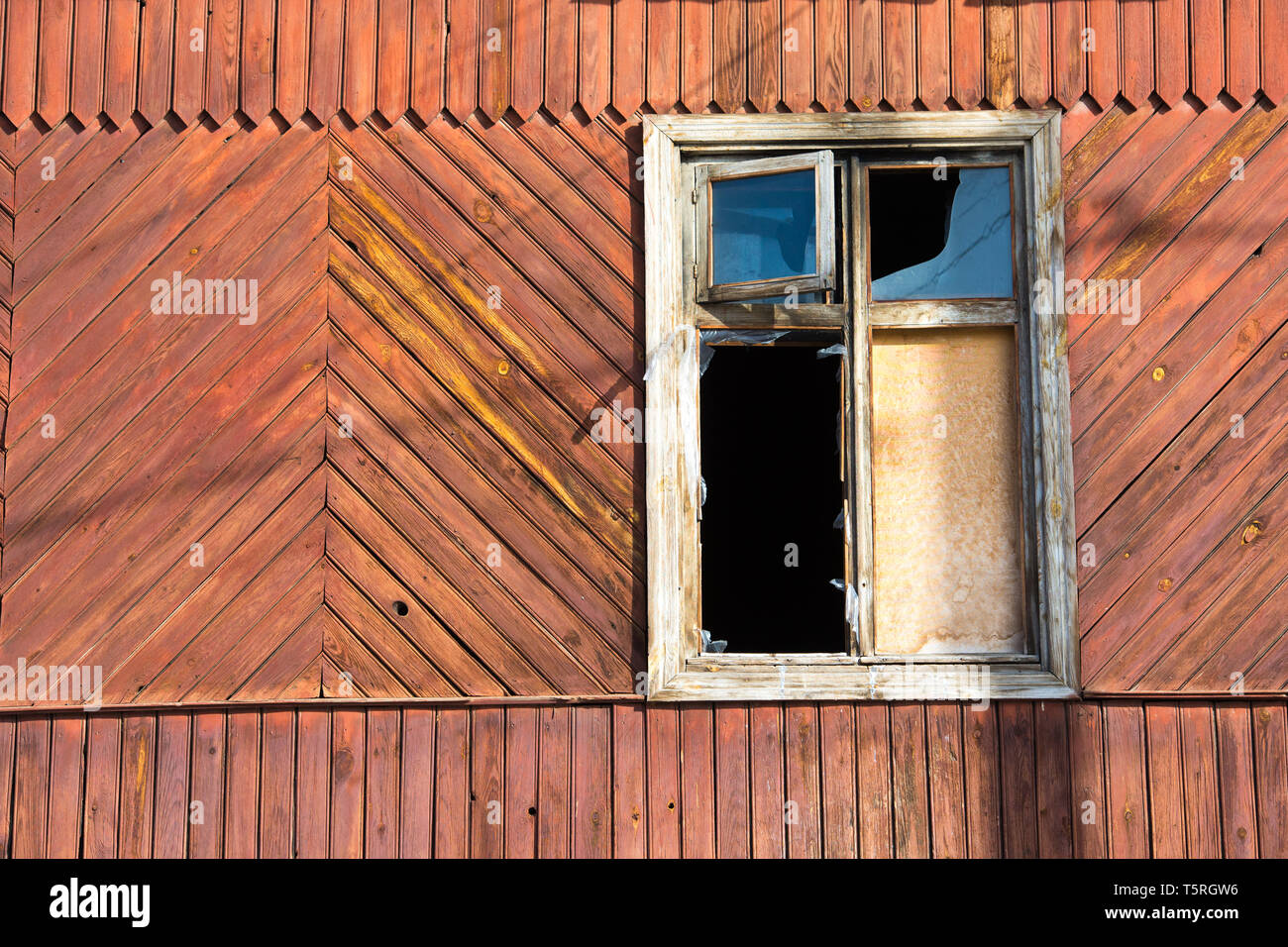 window of an abandoned wooden house, an old weathered window on an ...