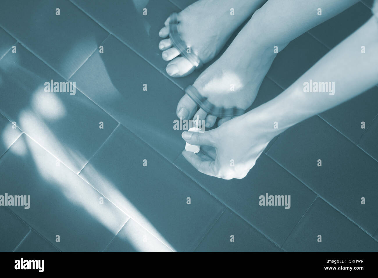 Young woman with silicone toe separator to separate toes to pedicure ...