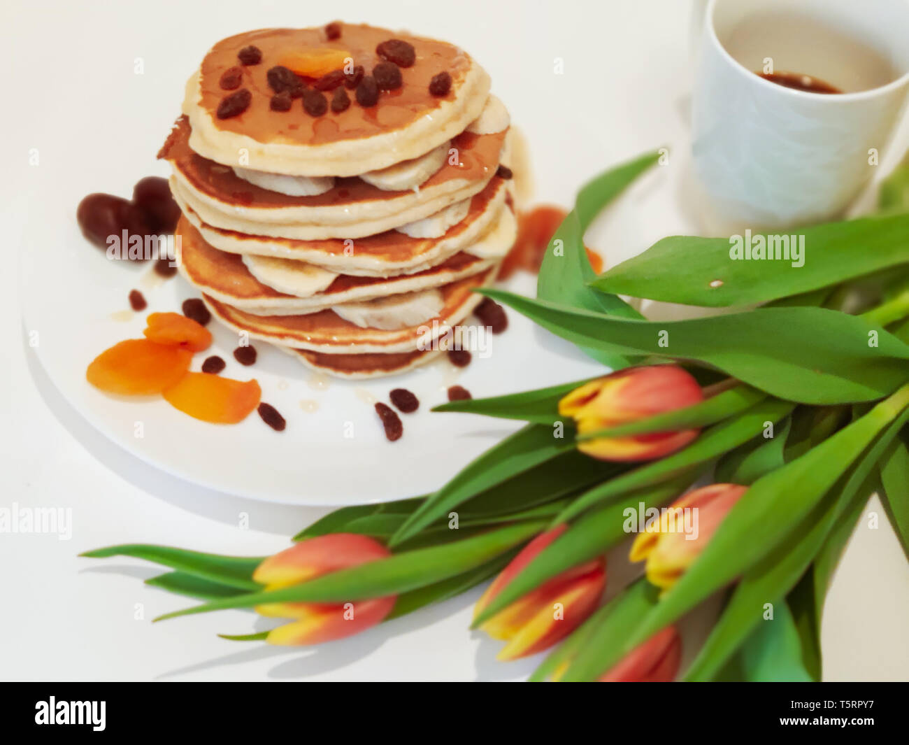 Stack of Pancakes on the Table with Tulips Stock Photo - Alamy