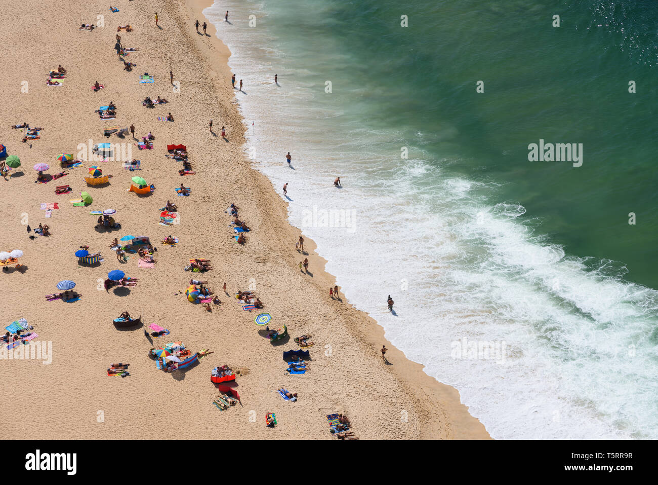 Aerial view of people sunbathing on the ocean beach at hot summer day ...