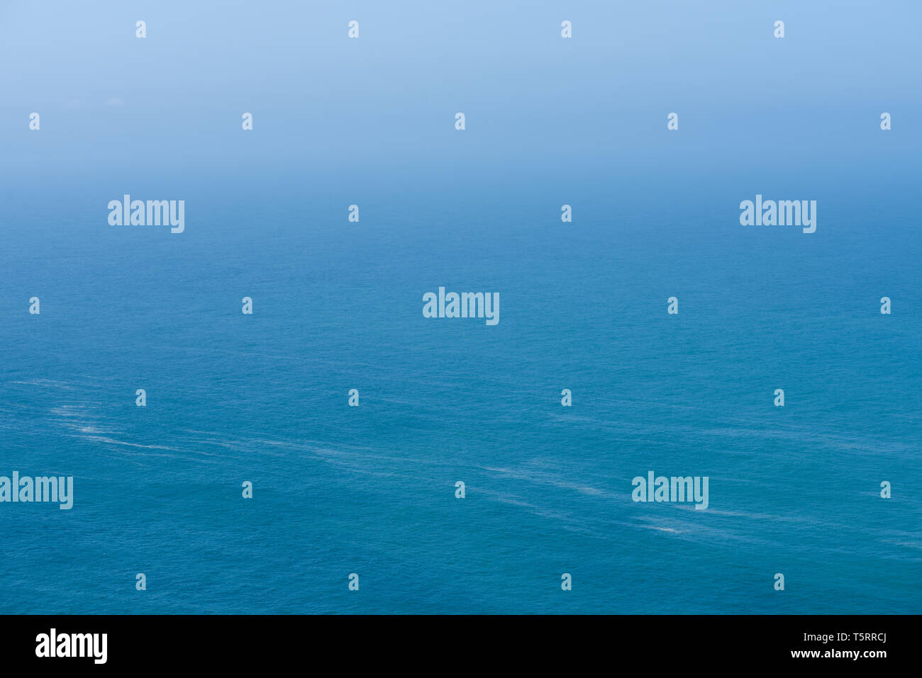 Aerial view of calm infinite ocean and blue sky background Stock Photo ...