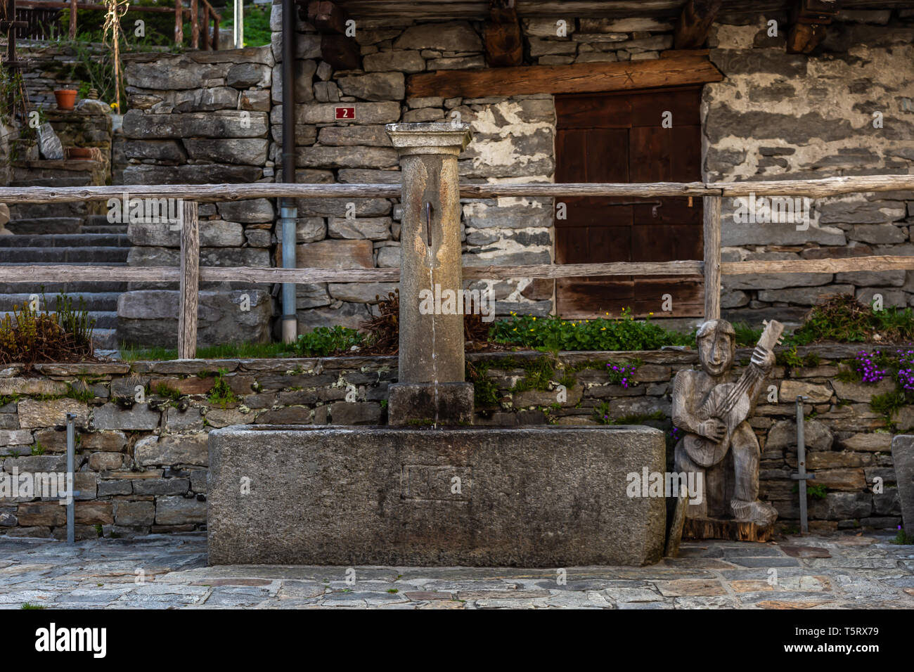 Rural fountain in mountain village Stock Photo - Alamy