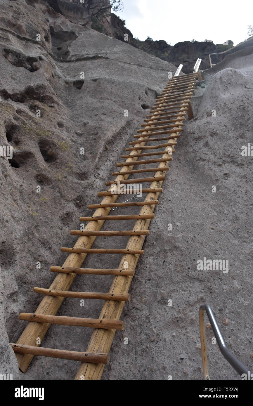 Extremely long ladder extending up into cliff dwellings of Bandelier ...