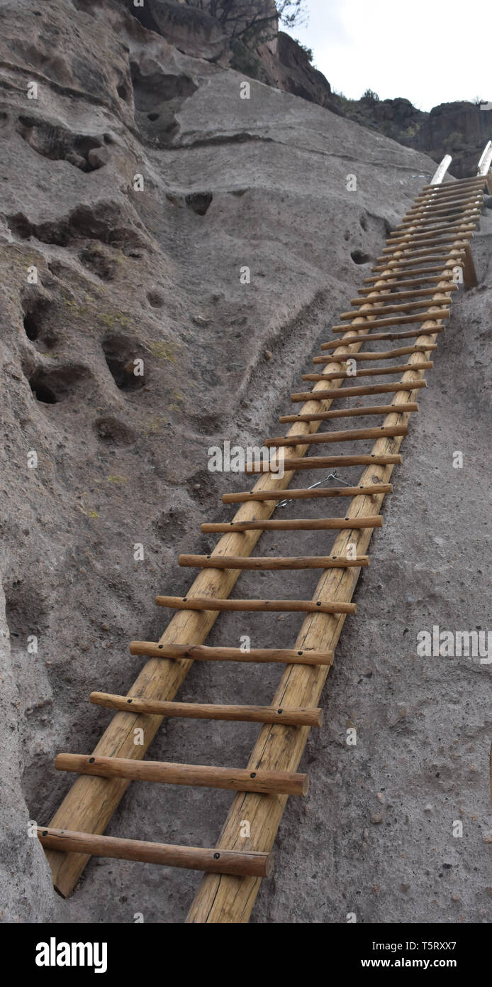 Ladder extending into the ancient sandstone cliff dwellings Stock Photo ...
