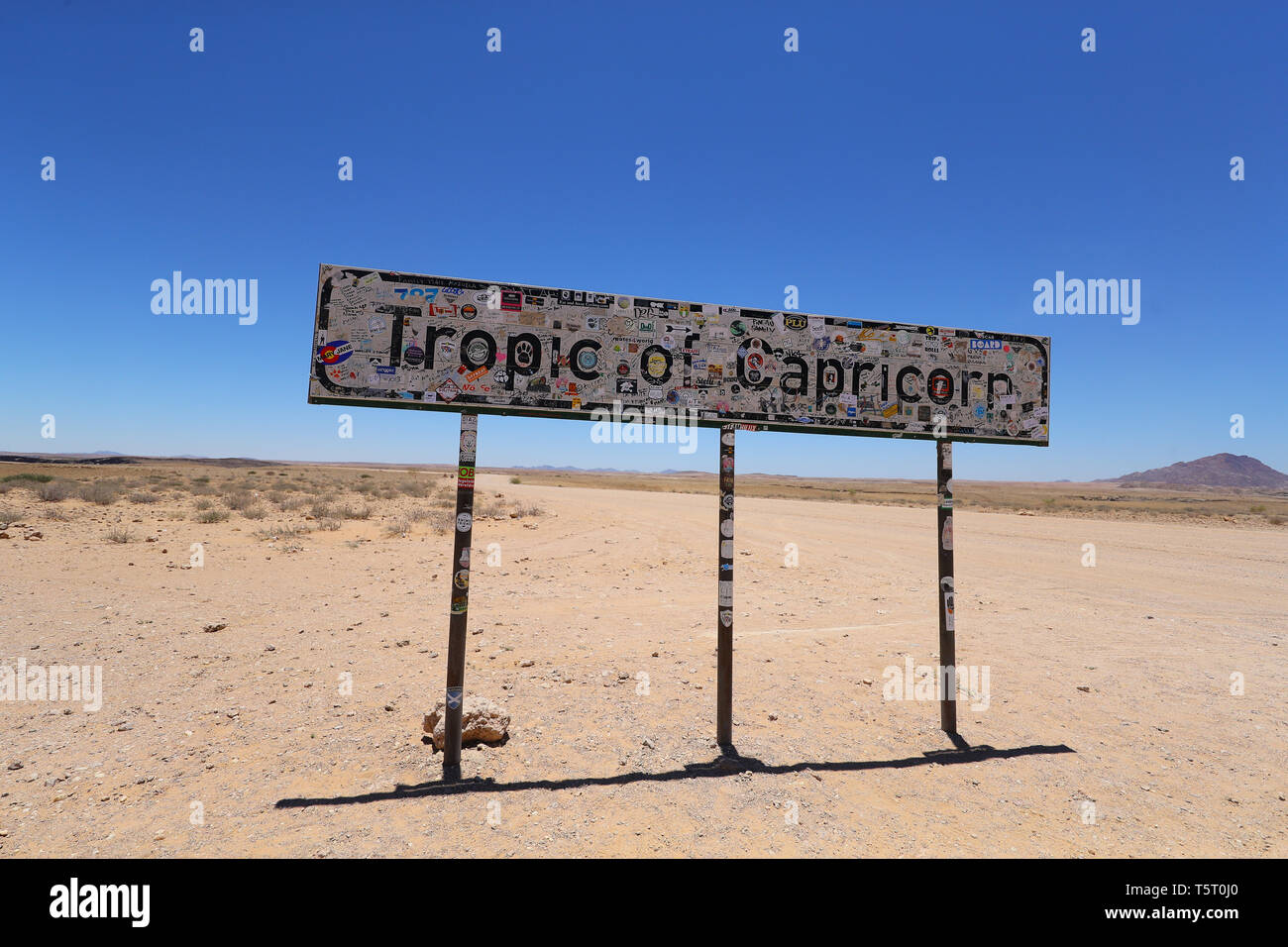 The Tropic of Capricorn latitude line and sign along a gravel road in ...