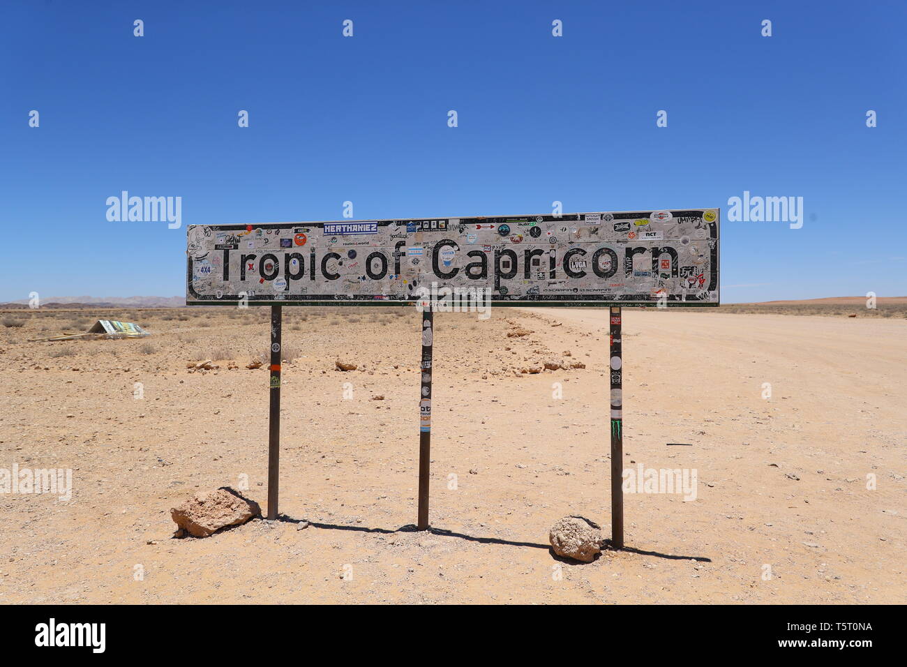 The Tropic of Capricorn latitude line and sign along a gravel road in ...