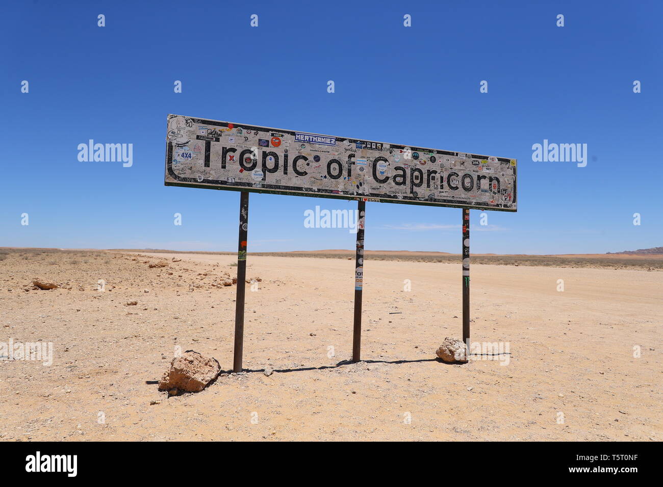 The Tropic of Capricorn latitude line and sign along a gravel road in ...