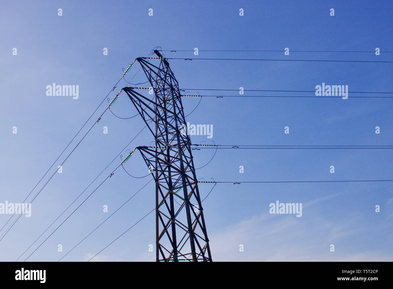 Electricity pylon with power cables against blue sky background - image ...