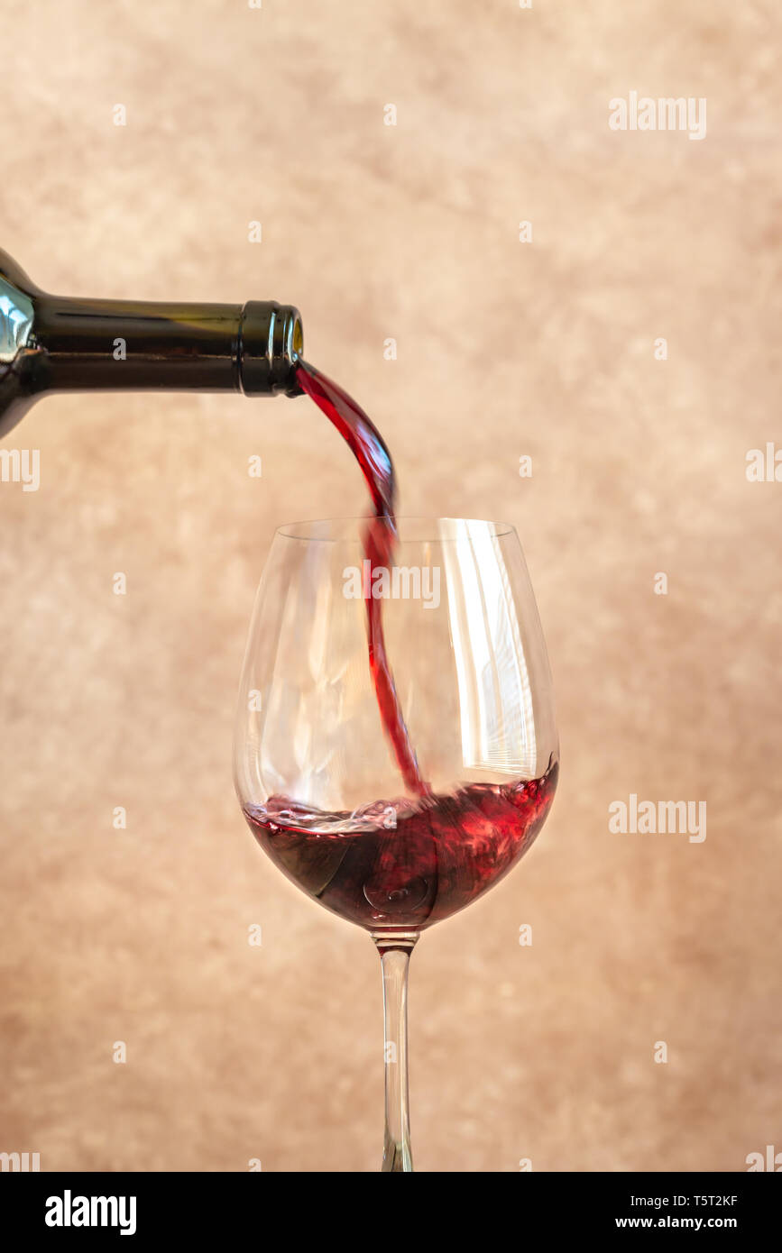 Red wine pouring into glass close-up Stock Photo - Alamy