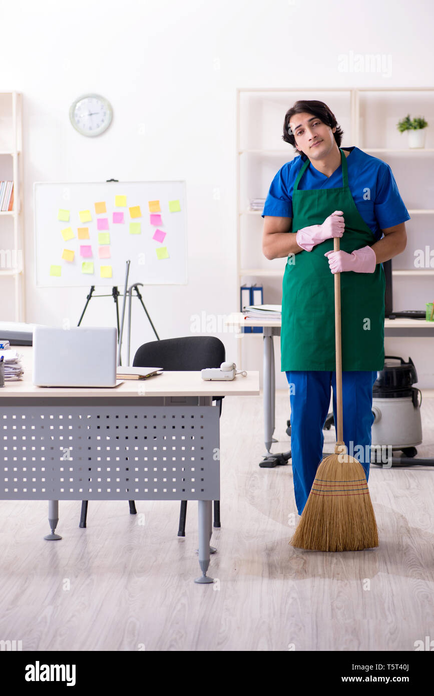 Male handsome professional cleaner working in the office Stock Photo ...