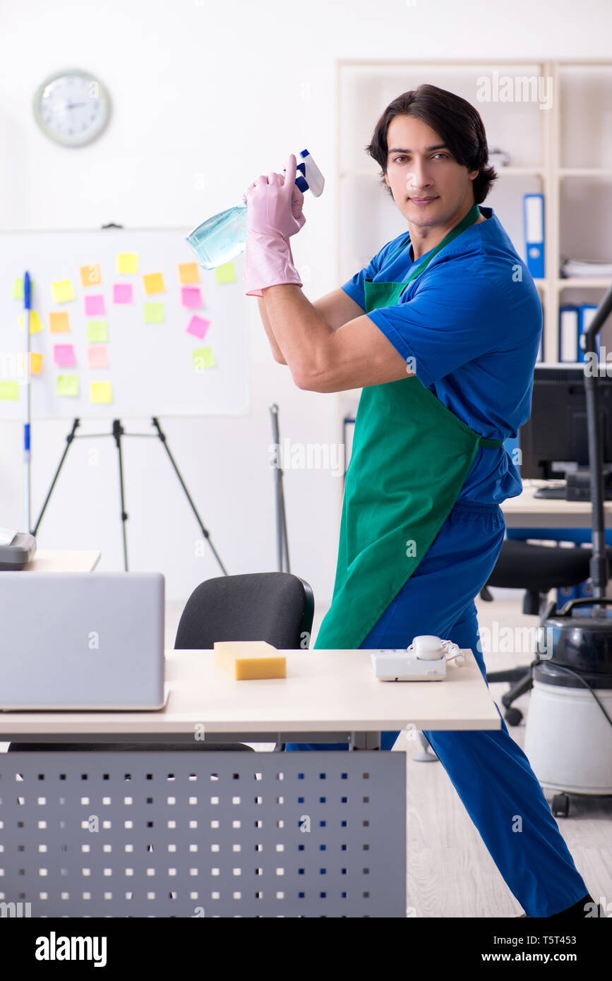 Male handsome professional cleaner working in the office Stock Photo ...