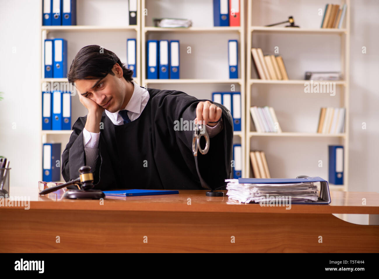 Young handsome judge working in court Stock Photo - Alamy