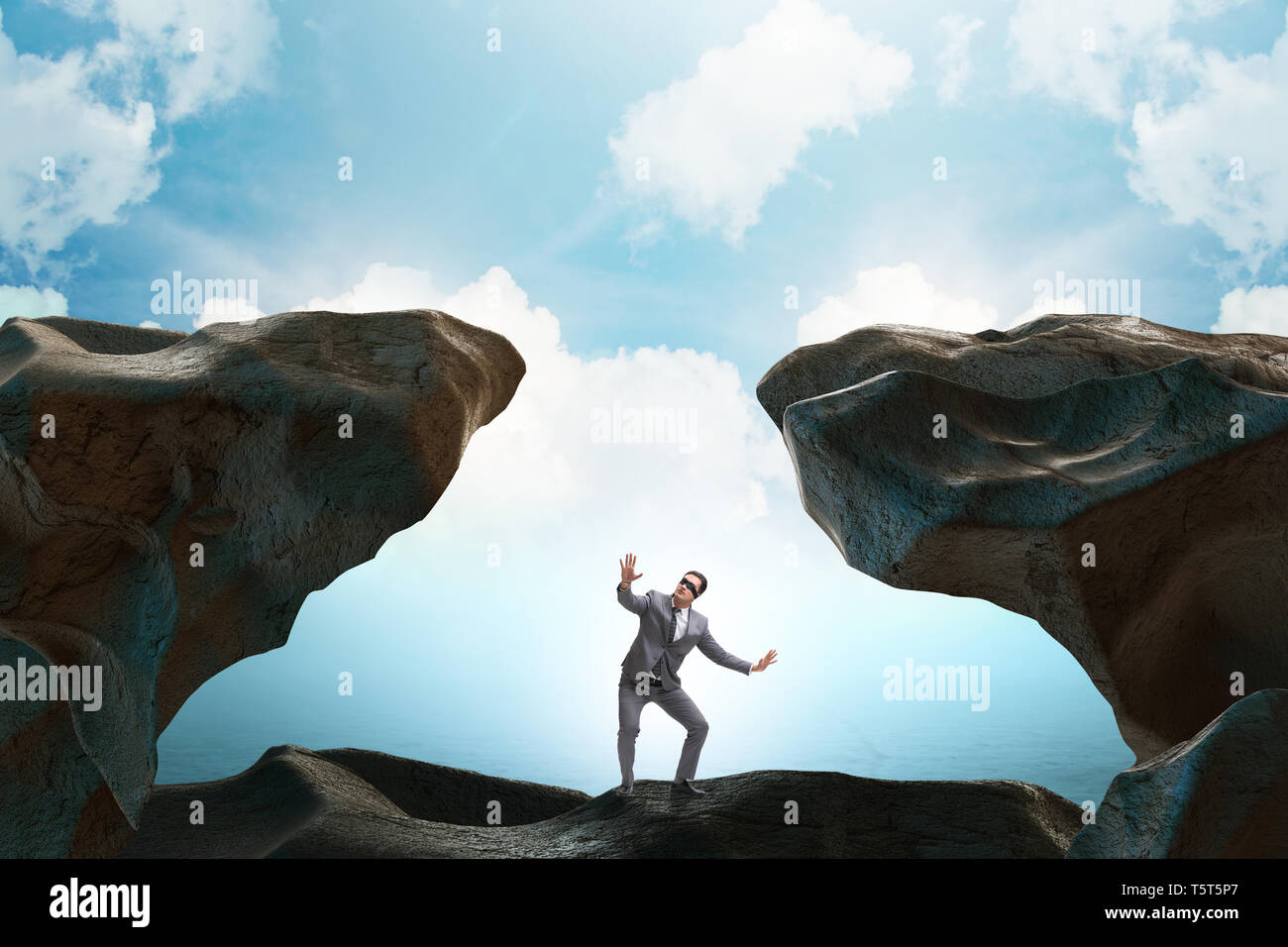 Businessman fallen to the gap in mountains Stock Photo - Alamy