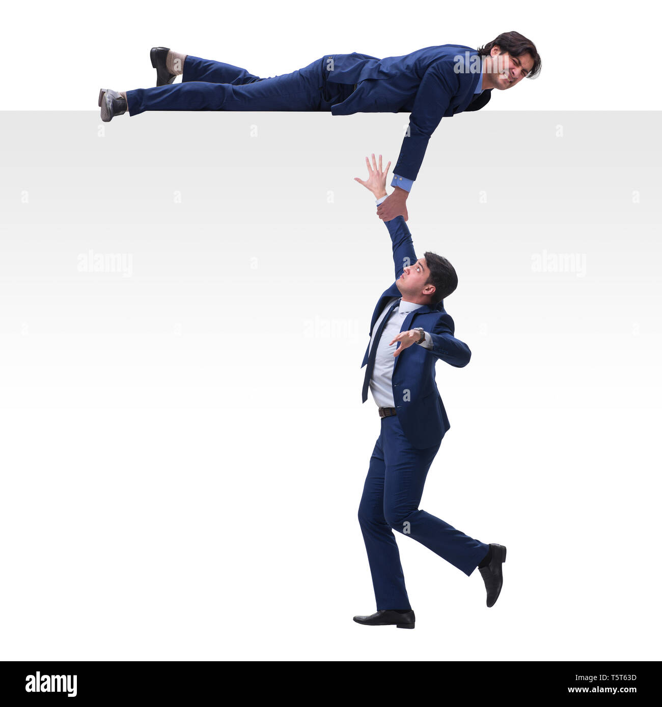 Businessman offering helping hand to falling colleague Stock Photo - Alamy