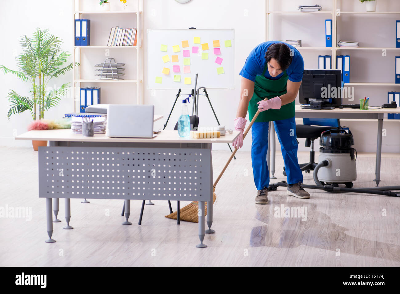 Male handsome professional cleaner working in the office Stock Photo ...