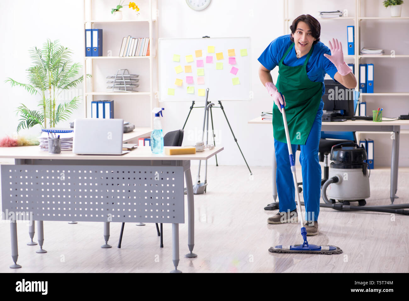 Male handsome professional cleaner working in the office Stock Photo ...