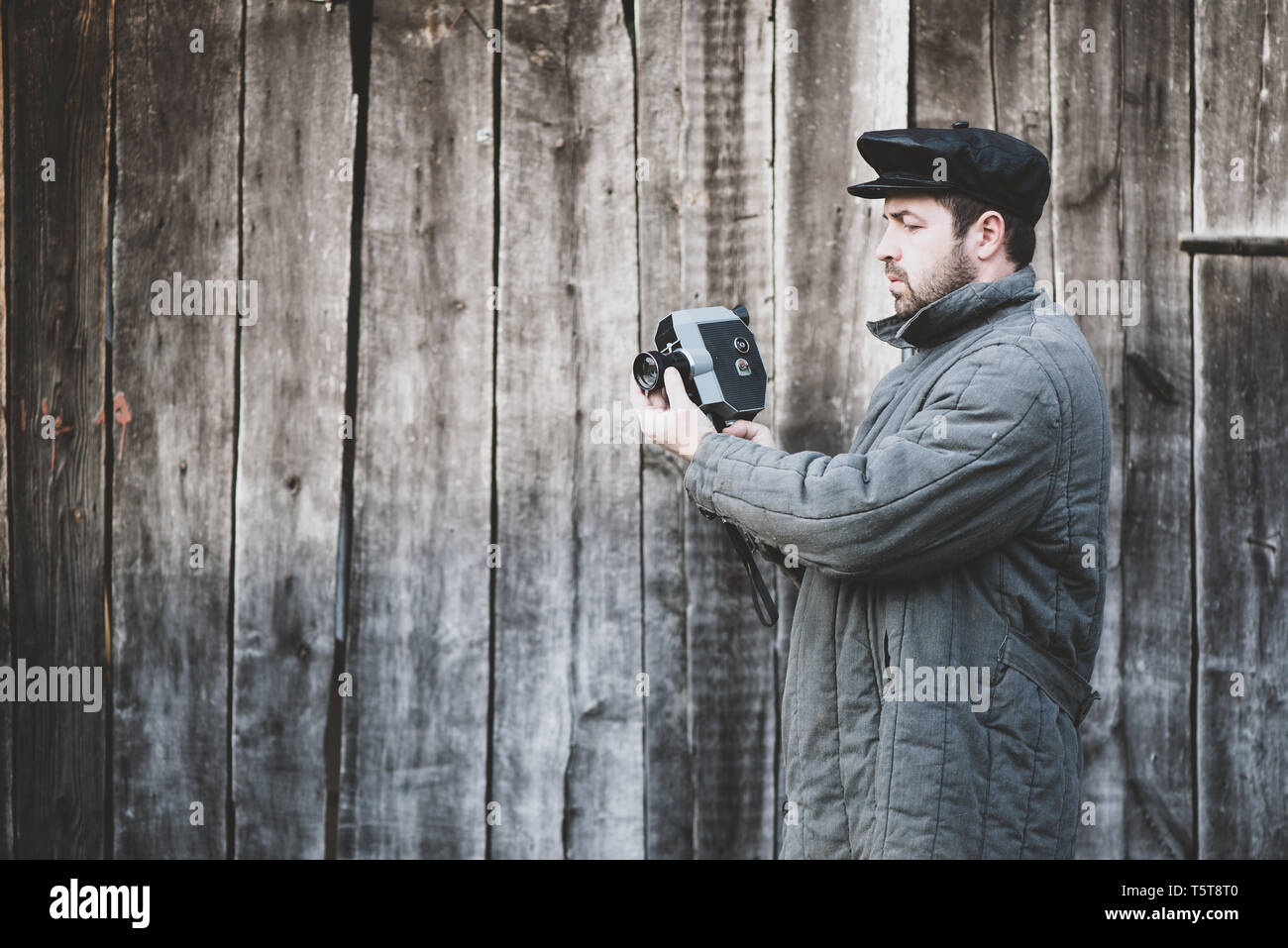 Old-fashioned cameraman with retro camera in hands, matte effect ...