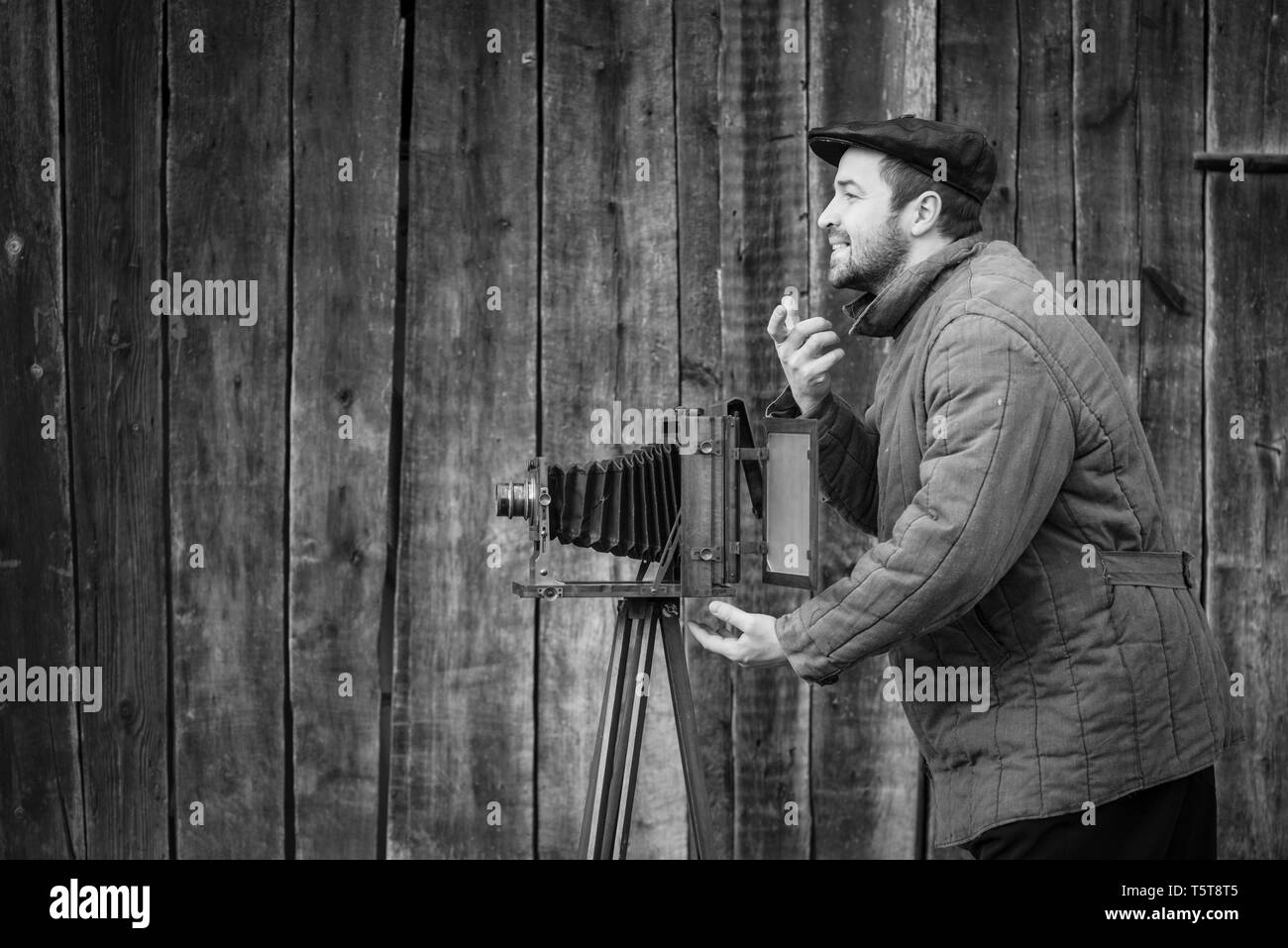 Old fashioned photographer asks for a smile. Works on large format ...