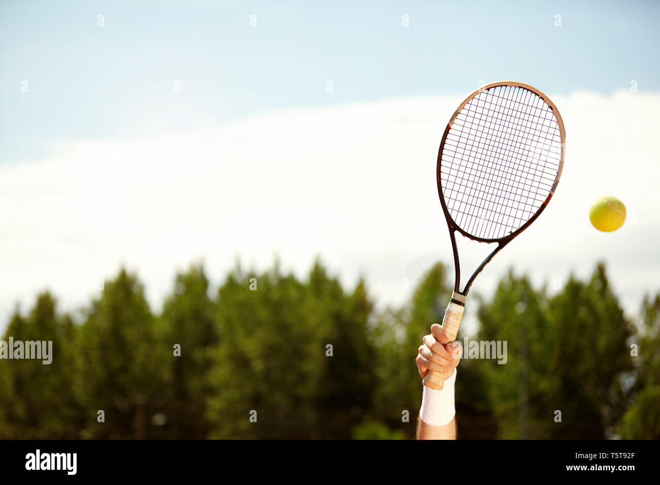 Close up of tennis racket up in air Stock Photo - Alamy