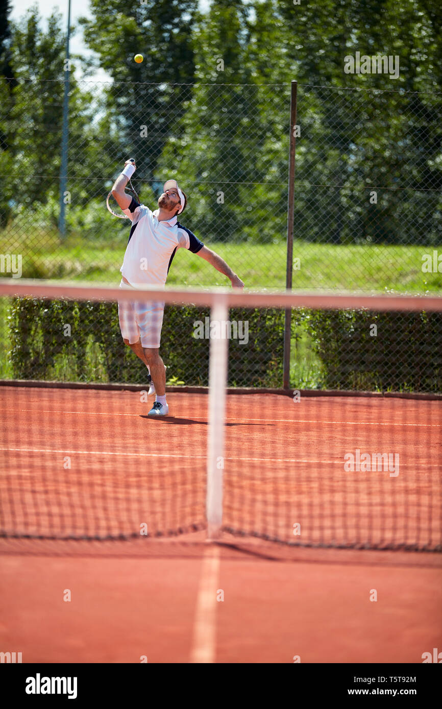 Tennis player with racket up waiting ball Stock Photo - Alamy