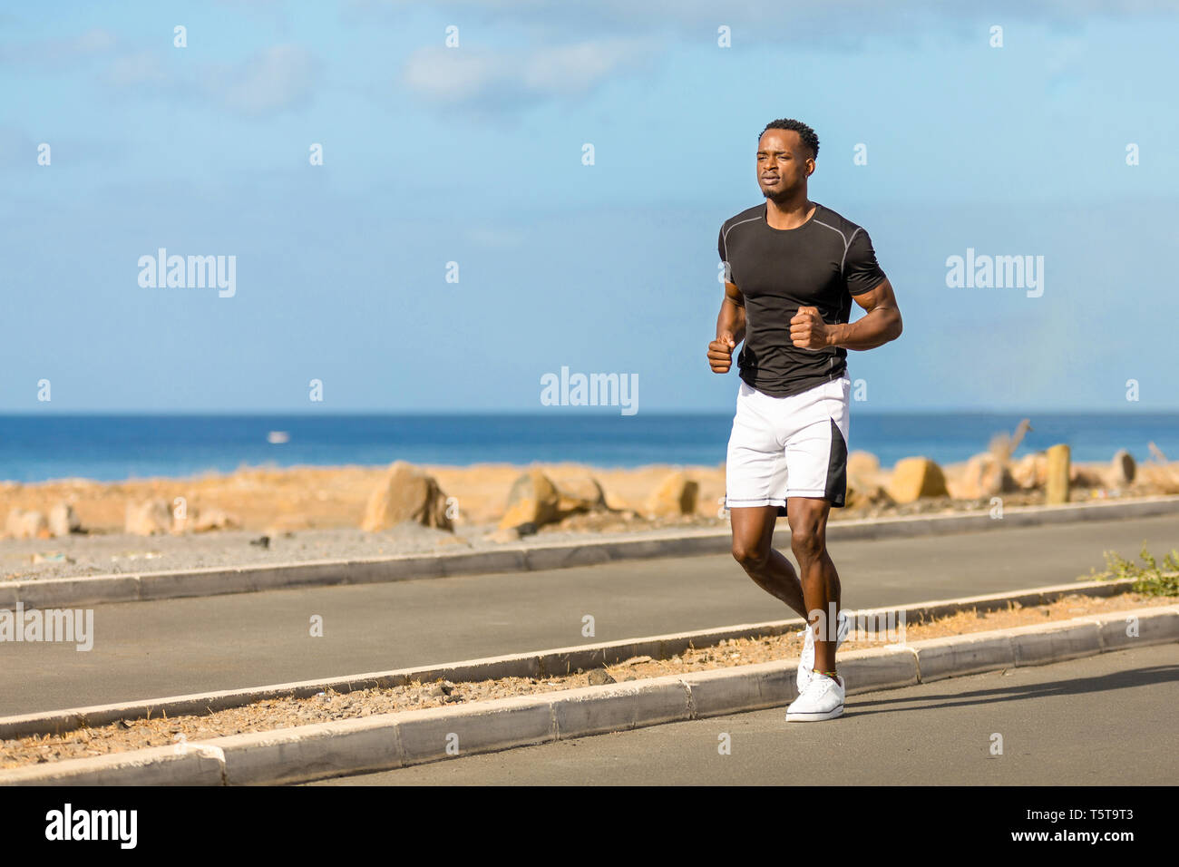 Black african american young man running outdoor Stock Photo - Alamy