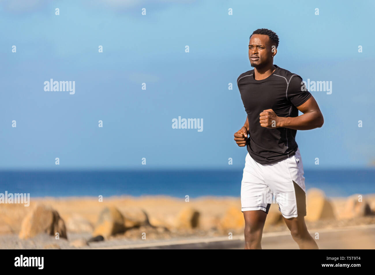 Black african american young man running outdoor Stock Photo - Alamy