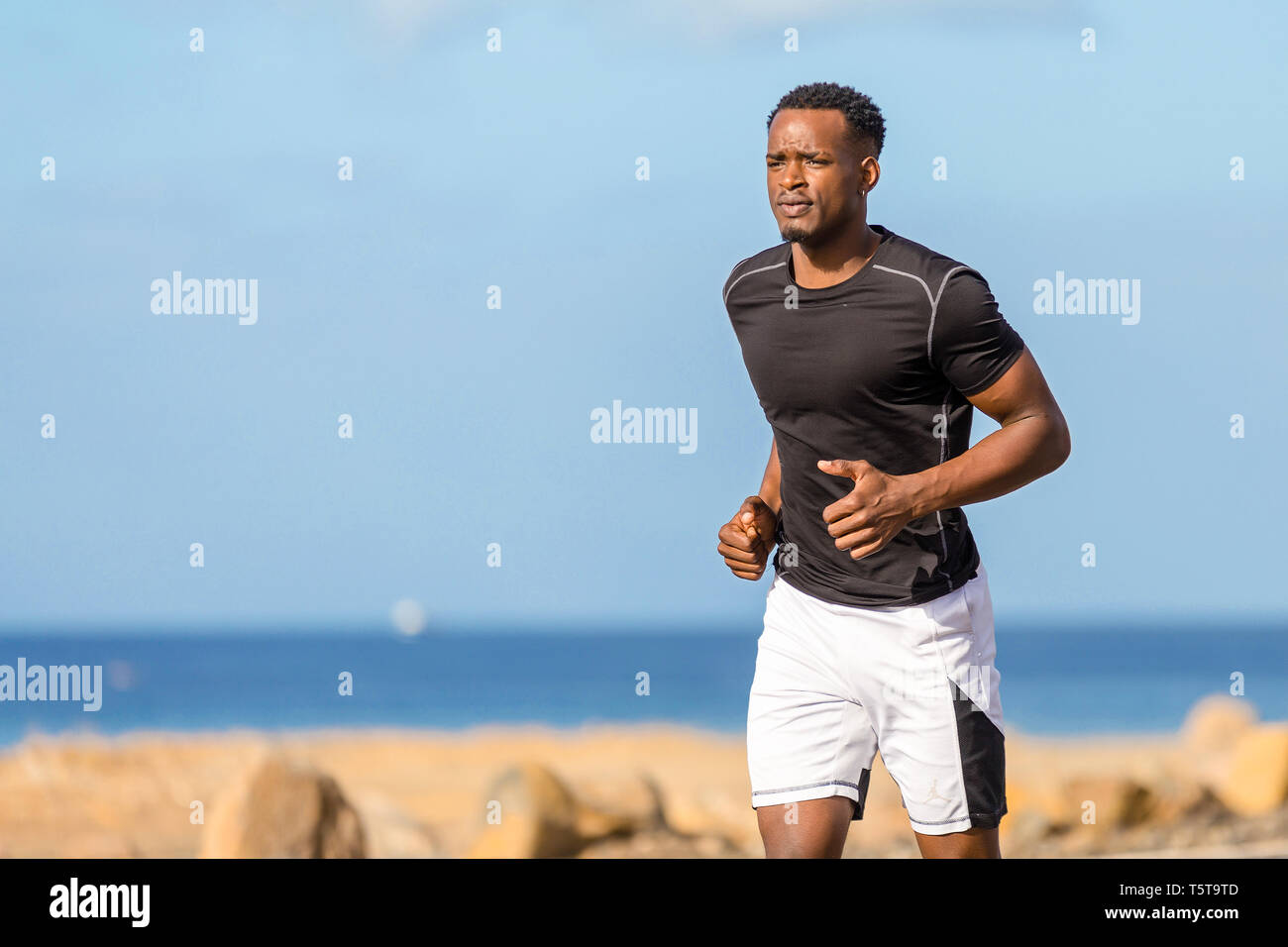 Black african american young man running outdoor Stock Photo - Alamy