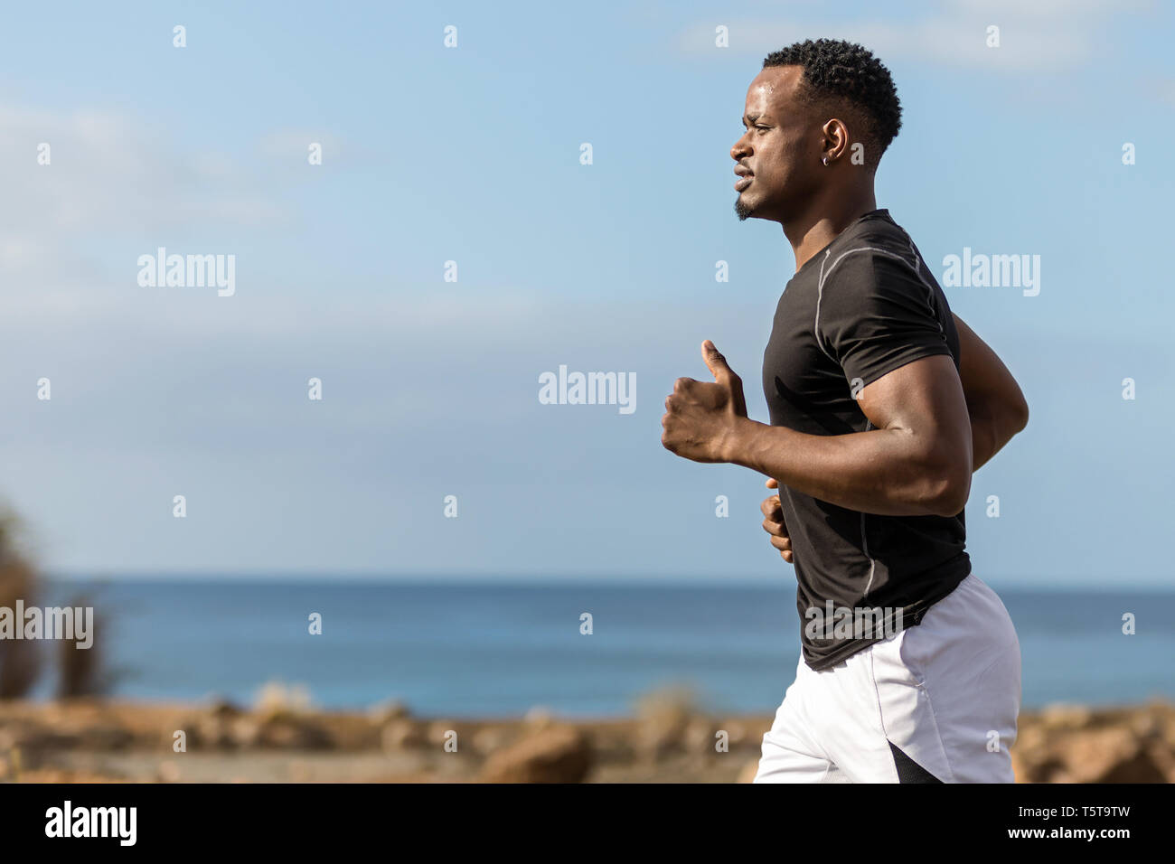 Black african american young man running outdoor Stock Photo - Alamy