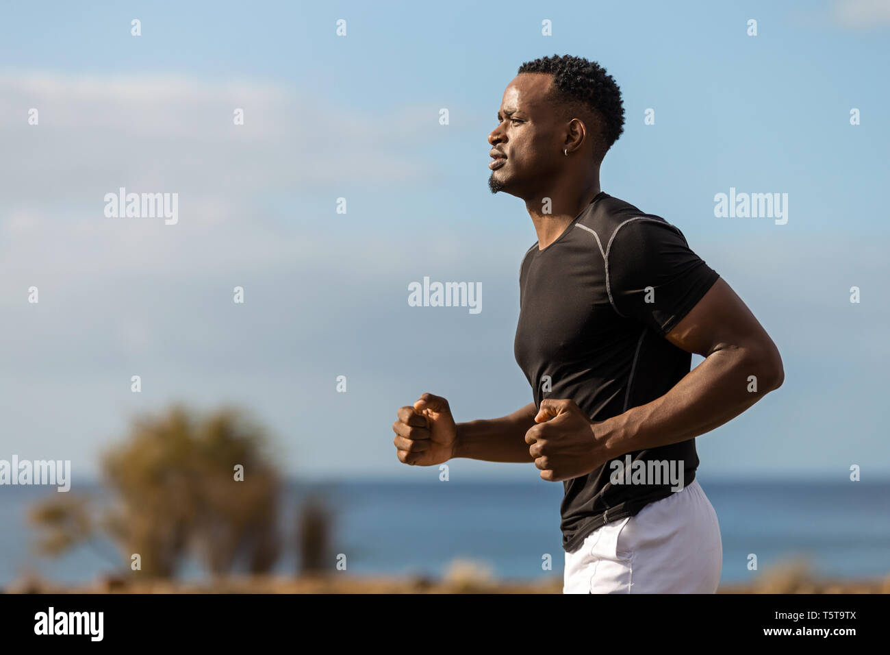 Black african american young man running outdoor Stock Photo - Alamy